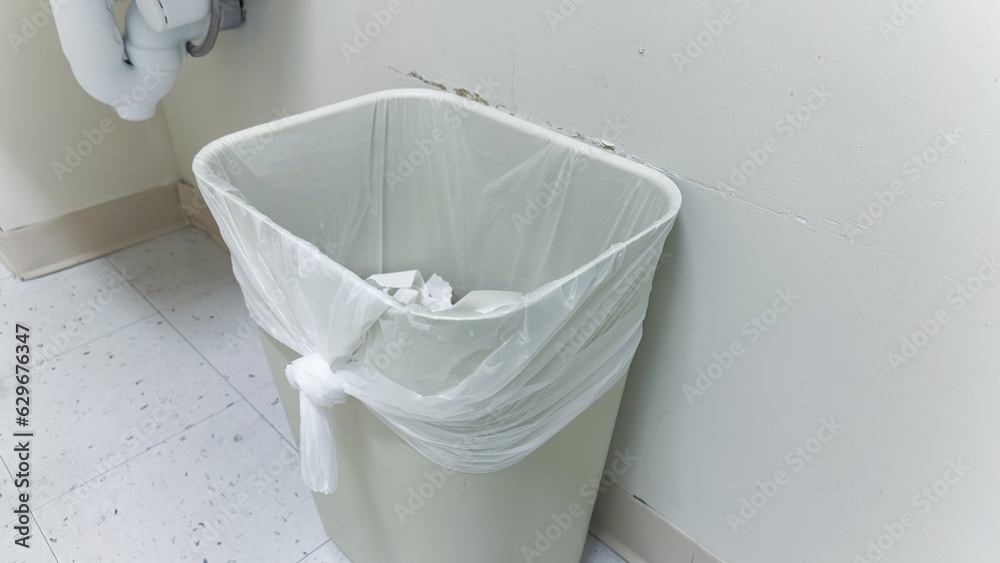 urban debris, a solitary trashcan stands as a symbol of waste, neglect ...