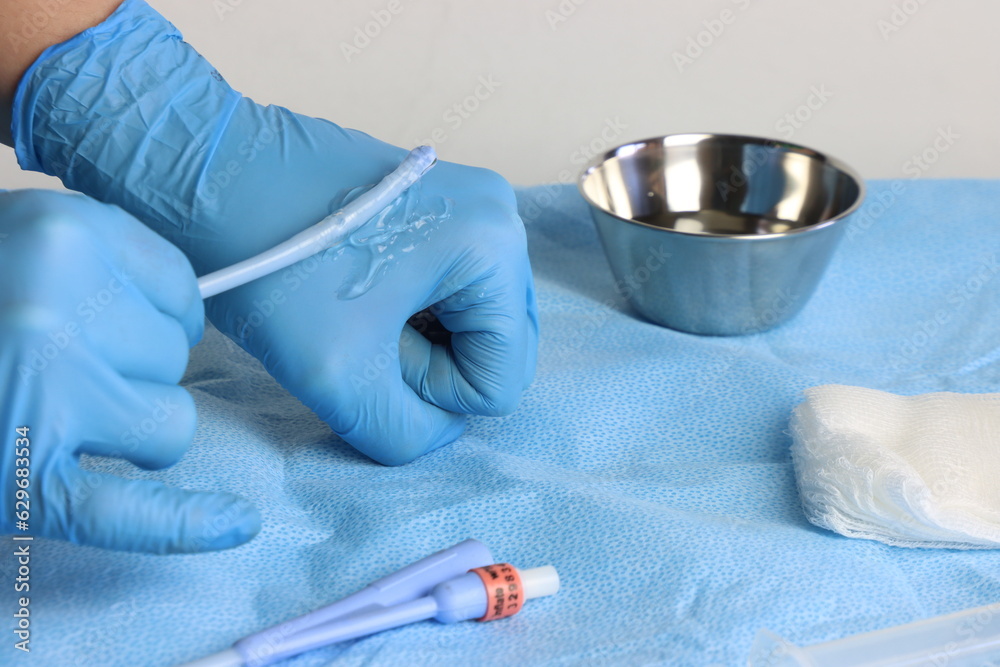 Foley catheter in a healthcare professional passing the lubricant in ...