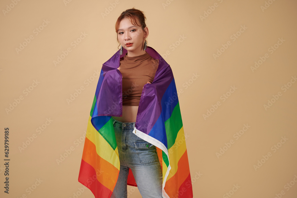 Young transgender woman wrapping in striped flag Stock Photo | Adobe Stock
