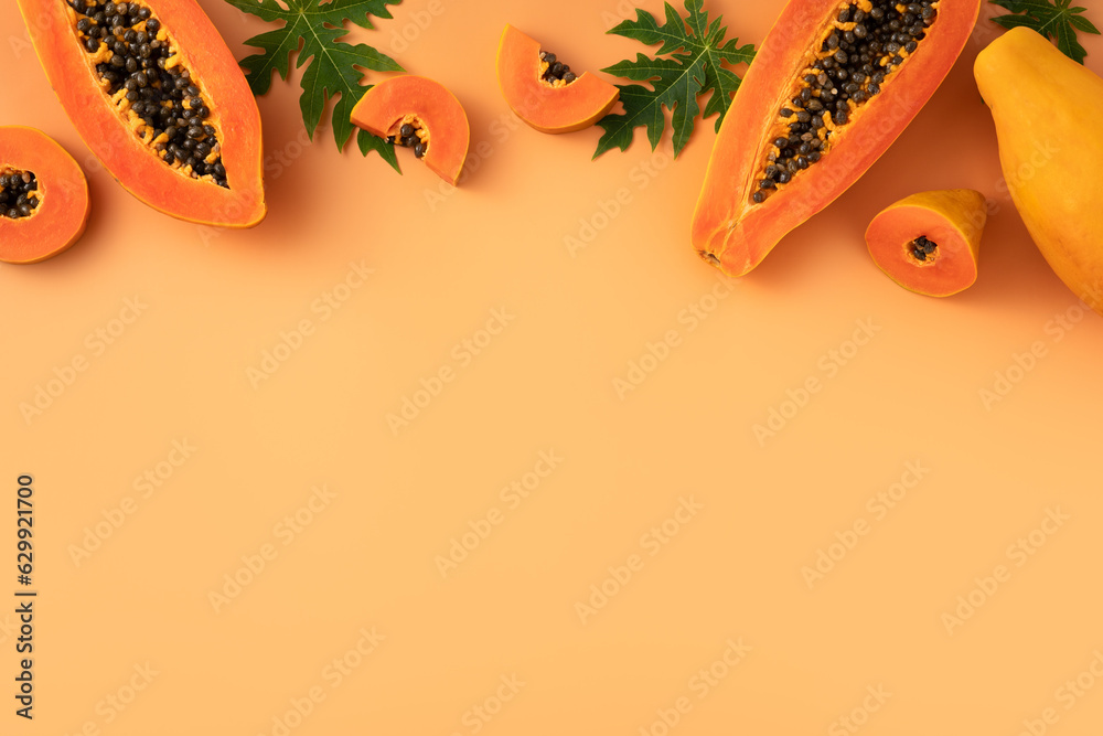 Cut Papaya over orange table background for tropical fruit design ...