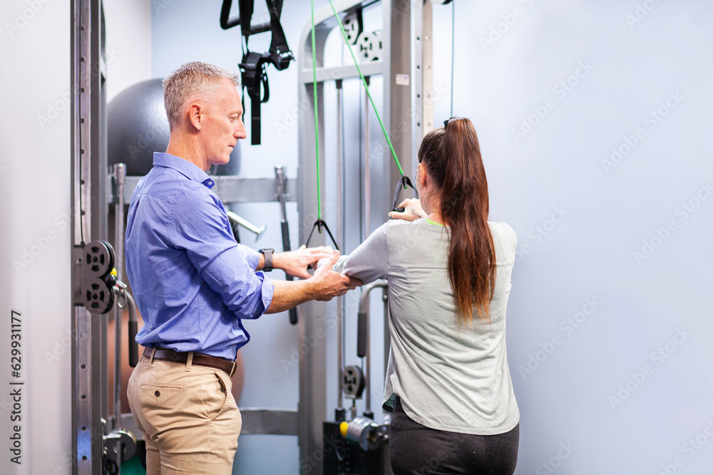 Physio adjusting clients posture in clinic during rehabilitation ...