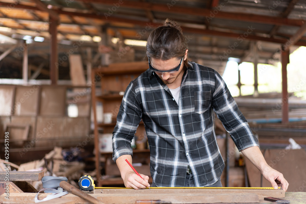 Carpenter man in casual clothes and wearing goggles protective using ...