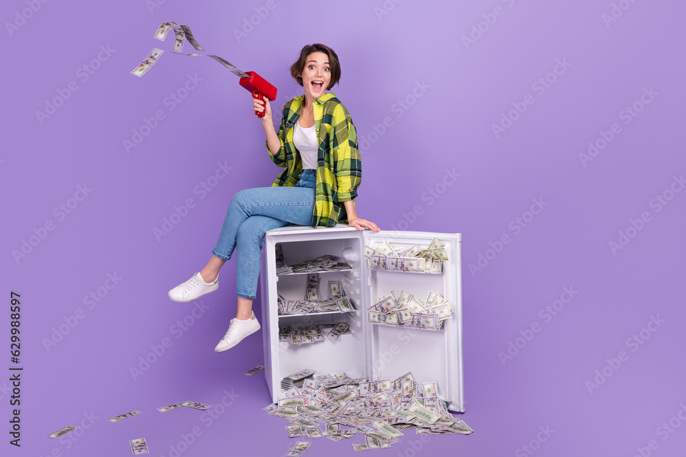 Full body photo of young crazy girl rejoice shoot gun pistol winner ...