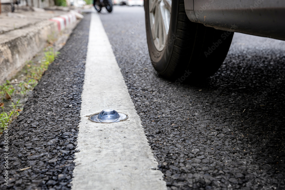Round glass reflector on the road . Road reflector for night ride ...