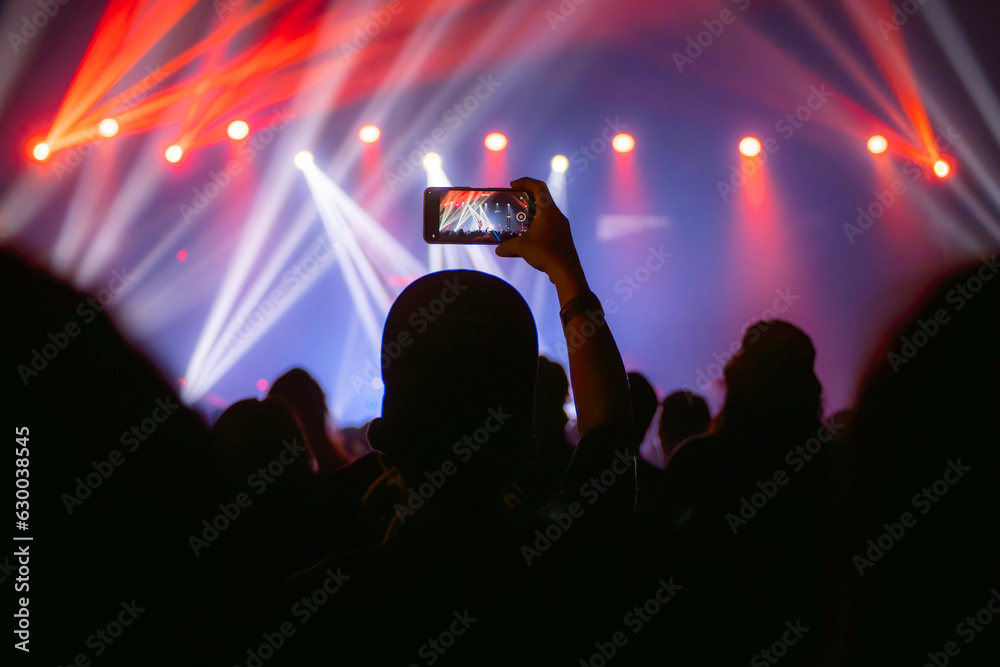 crowd holding smart phone and recording and photographing in concert ...