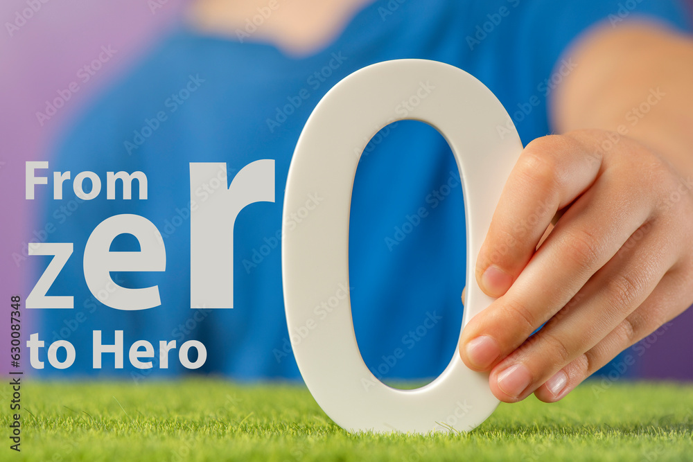 From Zero to Hero. Close-up concept photo of a hand holding a white ...