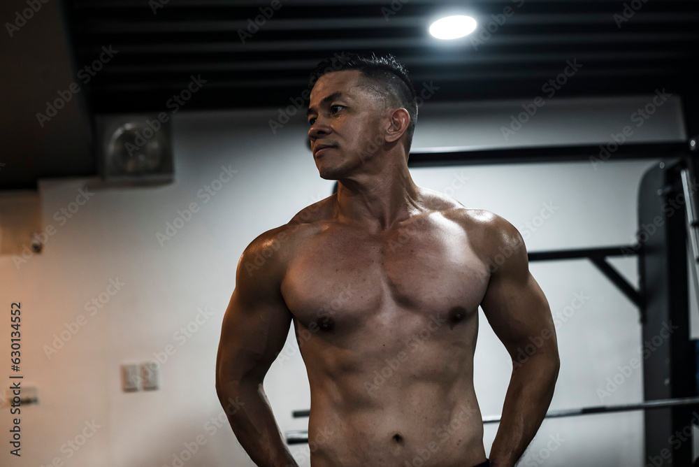 Candid Shot Of A Handsome Asian Man Checking Out His Shirtless Physique