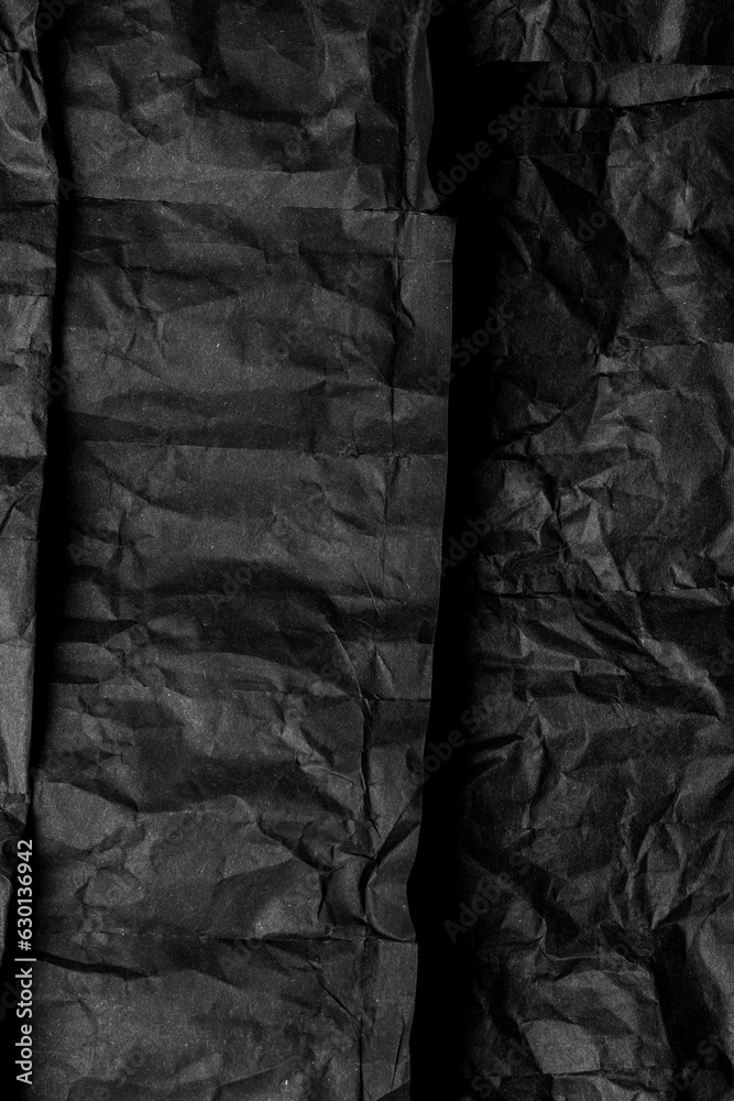 A sheet of black wrinkled paper. Texture of black crumpled paper. Dark ...