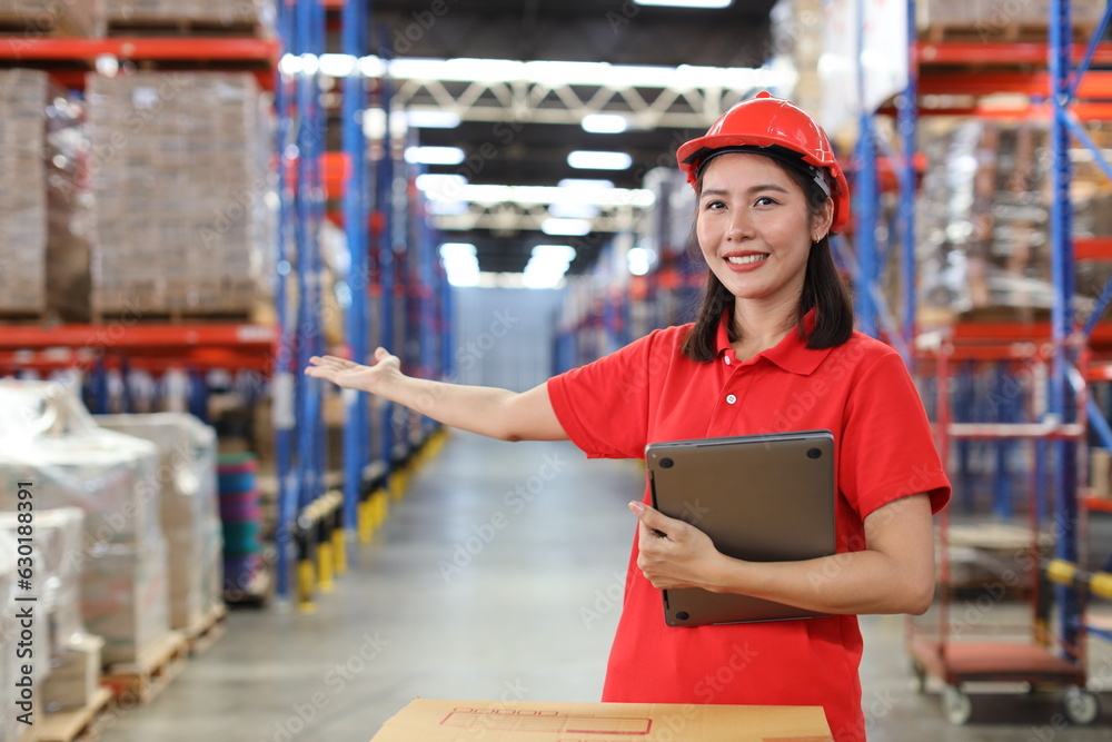 Portrait of warehouse workers young asian woman standing and using ...
