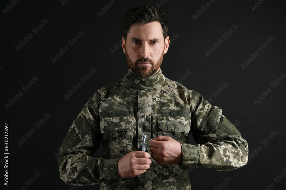 Soldier pulling safety pin out of hand grenade on black background ...