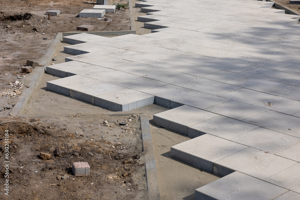 Modern square paving slabs. Construction of a new pedestrian road in ...