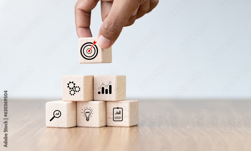 Business success goals Concept. Hand holding target board which ...