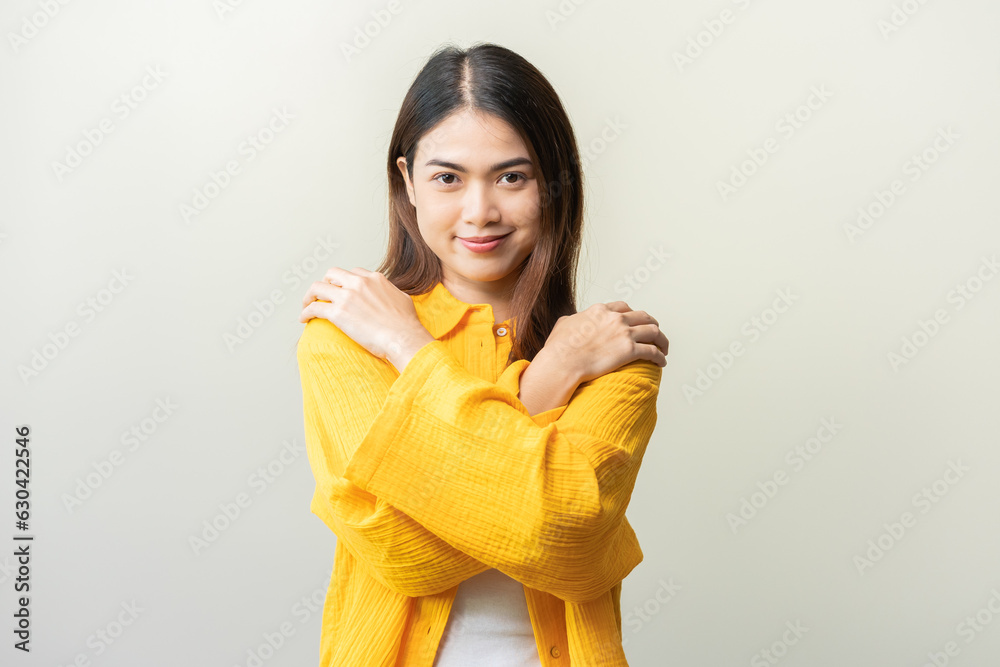 Smiling positive, hugging oneself happy asian young woman hands hug ...