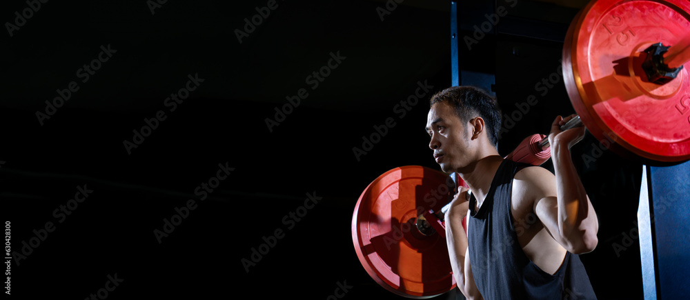 handsome muscular asian young man weight lifting with olympic barbell ...