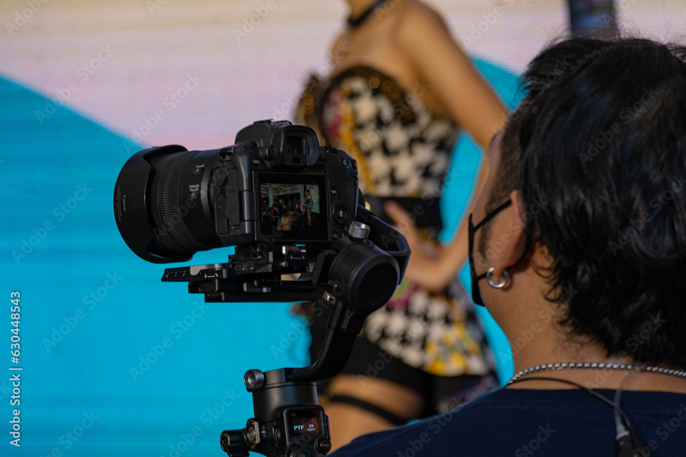 young man turning his back and then use the camera to stabilize Filming ...