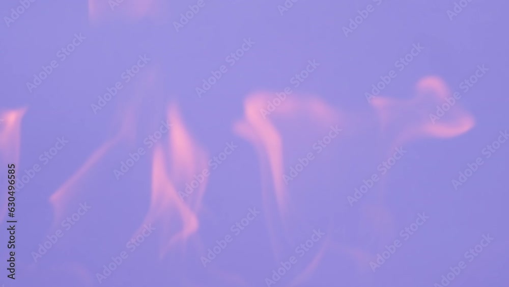 Gentle pink flames on a purple background. Slow-motion video of fire ...