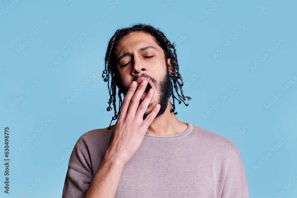 Tired arab man yawning while covering mouth with hand. Exhausted sleepy ...