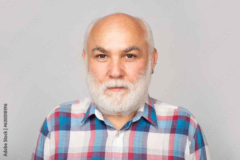 Mature bald man with grey beard on studio background. Portrait of ...