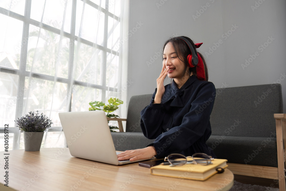 Asian student chatting or exchanging knowledge through laptop video ...