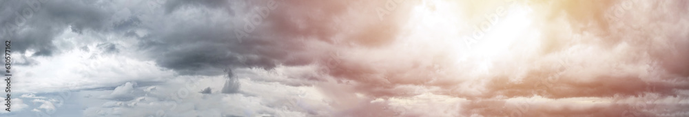 Panorama view of the grey sky with a touch of orange sunlight creates a ...