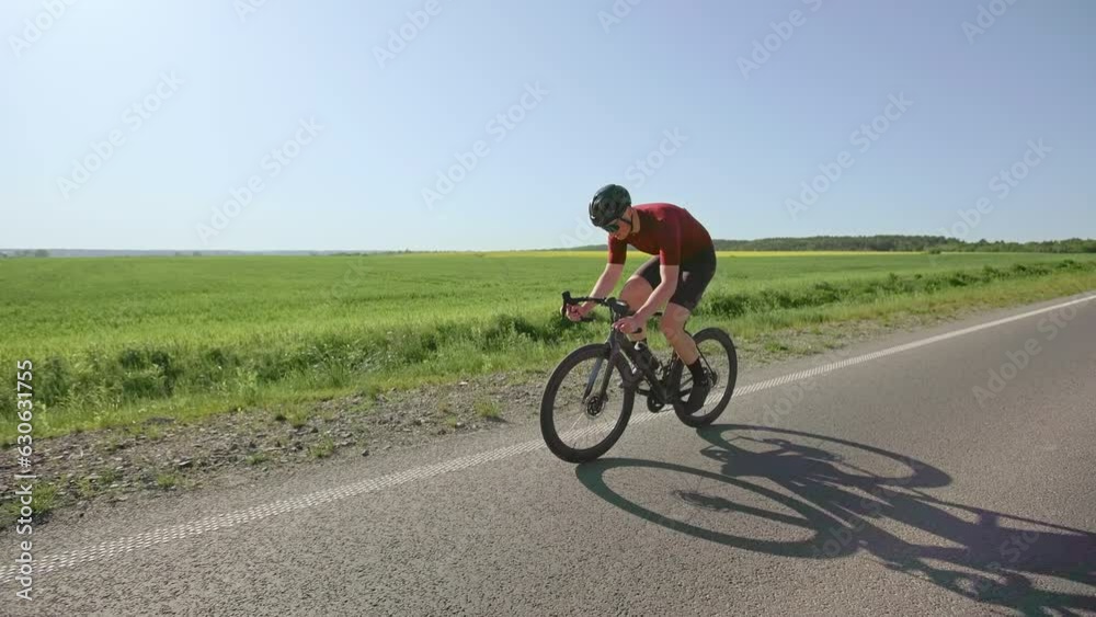 Active sports competitor putting hands on handlebars while wheeling ...