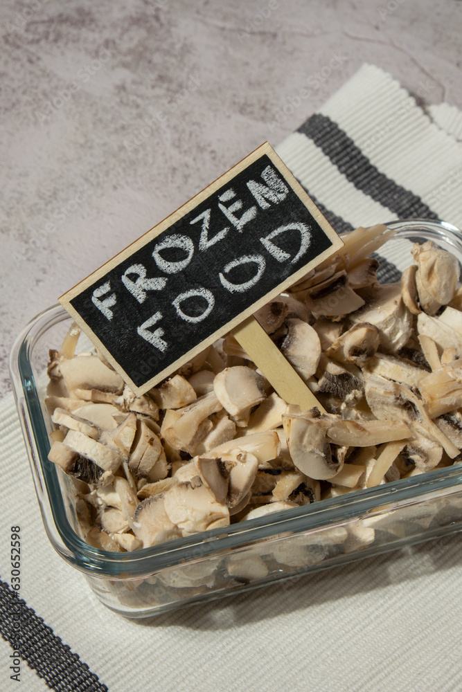 Frozen food sliced mushrooms champignon with blackboard wooden label ...