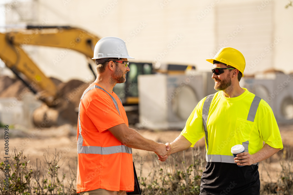 Two construction workers in helmet at building. Construction building ...