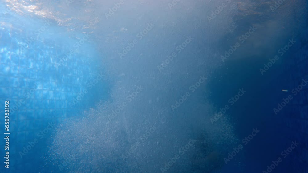 A man in a pose bomb jumps into a water. Male dives and rotation ...