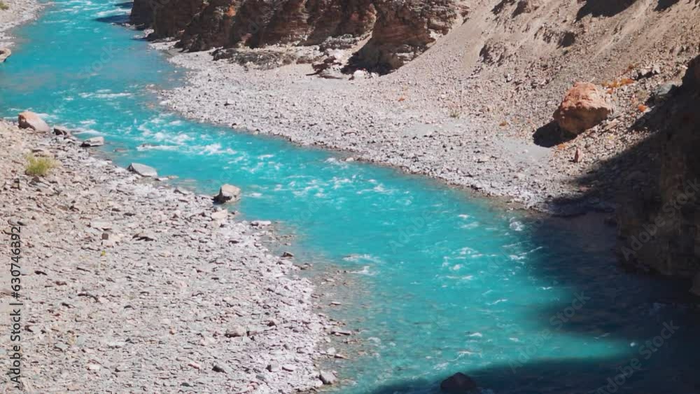 Blue Tsarap chu river flowing in the mountain valley of Zanskar as seen ...