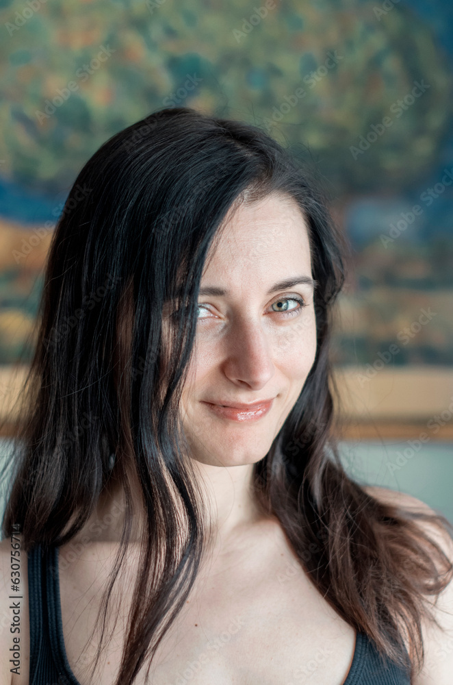 Lifestyle portrait of mid adult woman looking at camera at home. Nice ...