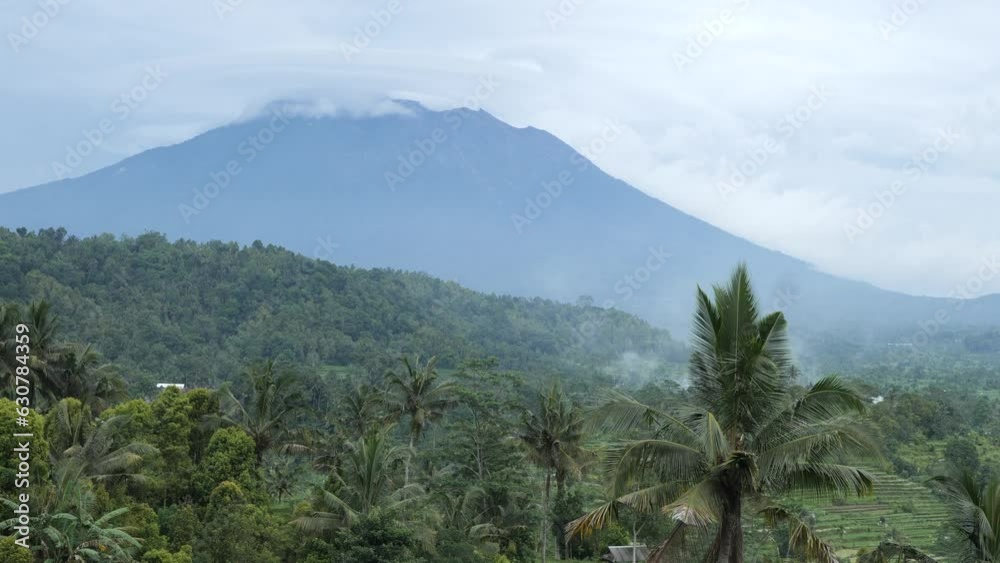 Cloud-covered volcano in Bali, Indonesia. Mount Agung volcano in Amed ...