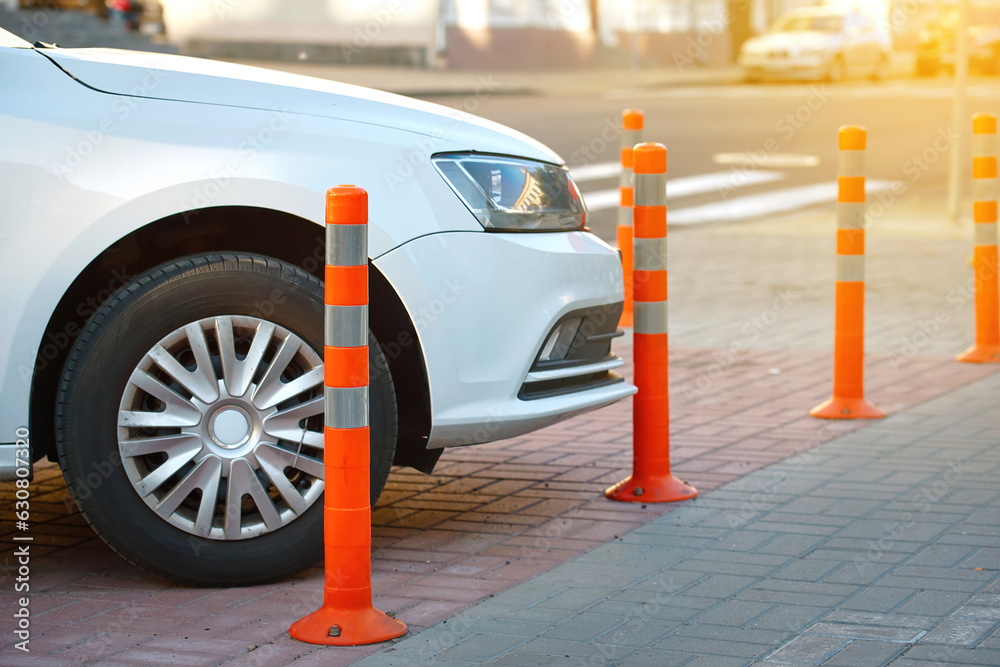 Car bumper and flexible plastic bollard on parking lot. Flexible ...