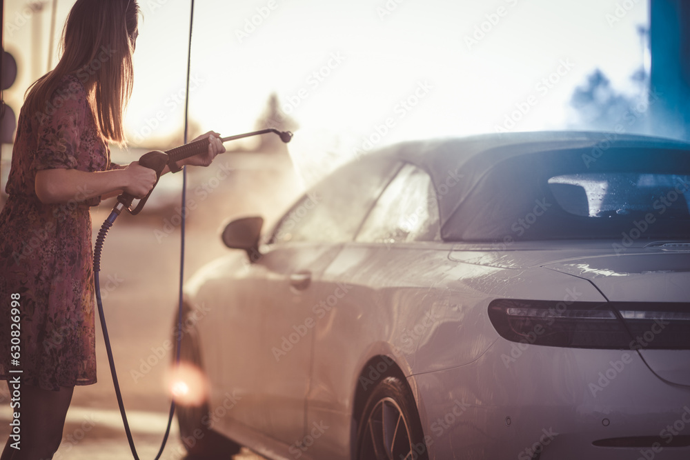Washing the convertible. Young woman washing her car. Washing the car ...