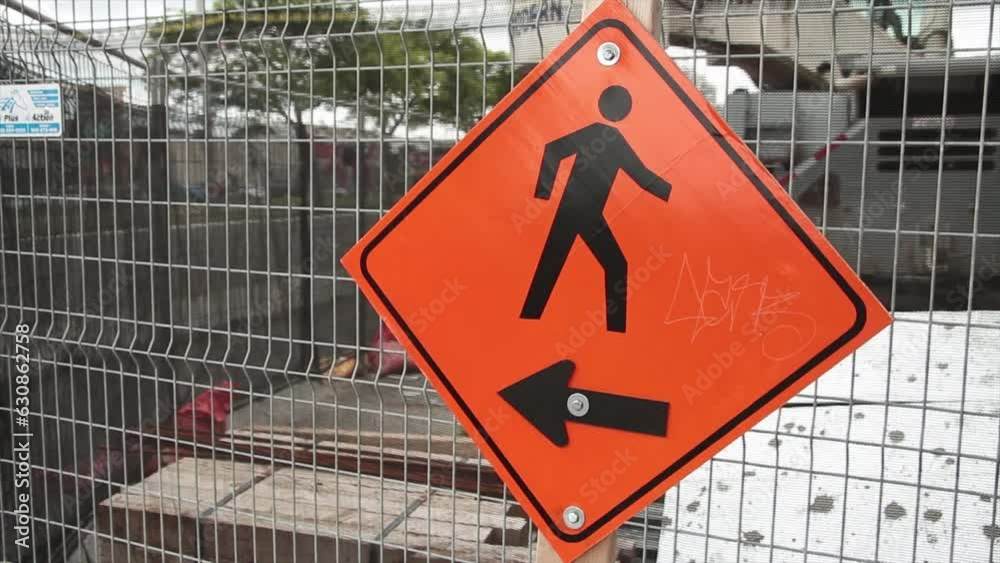 diamond orange sign with arrow pointing left and illustration of person ...