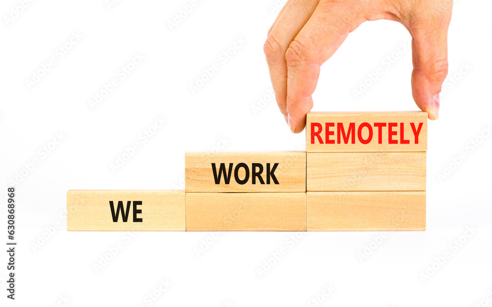 We work remotely symbol. Concept words We work remotely on wooden block ...