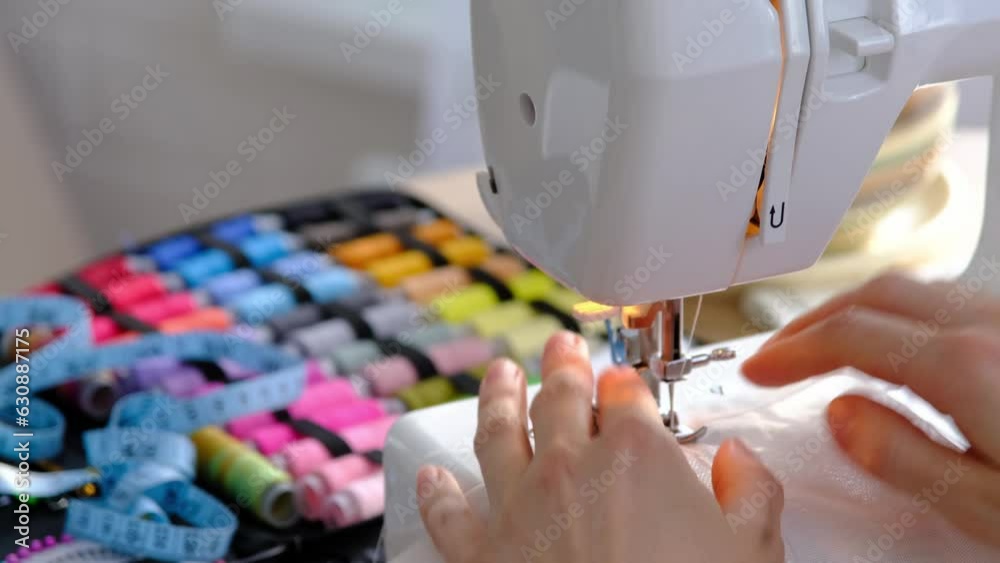 Woman hand close up sews tulle on electric sewing machine. Filling the ...