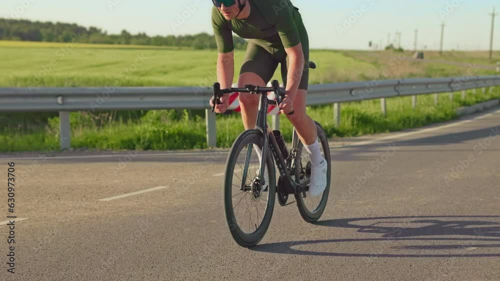 Young sports competitor boosting power on racing bike while cycling out ...