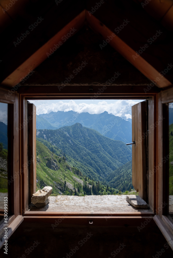 The view the green mountains from the window in a small hut, Bivacco ...