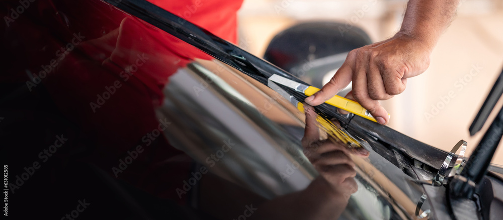 Car side window film removal and tinting installation. Male auto ...