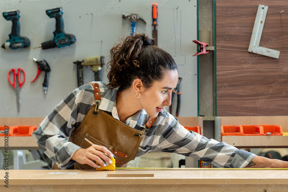 One Strong confident young aged women carpenter standing aim at wood ...