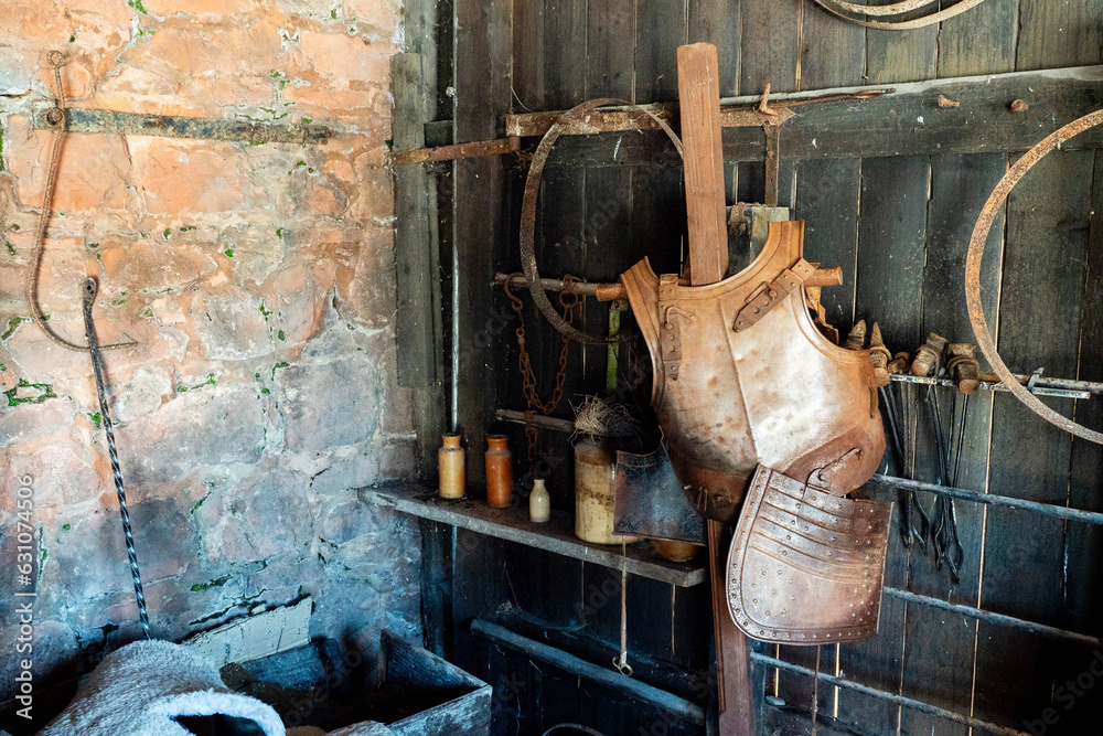 Old medieval body armor on display in blacksmith shop in a museum ...