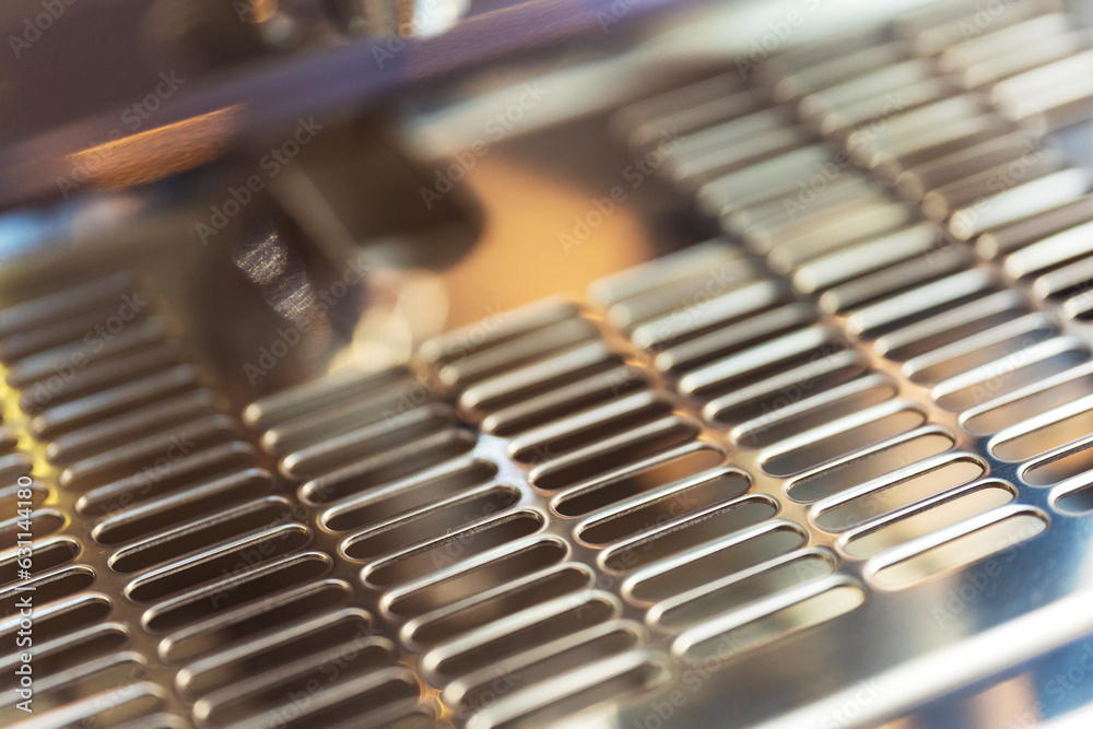 protective metal mesh on an industrial coffee machine. Drainage metal ...