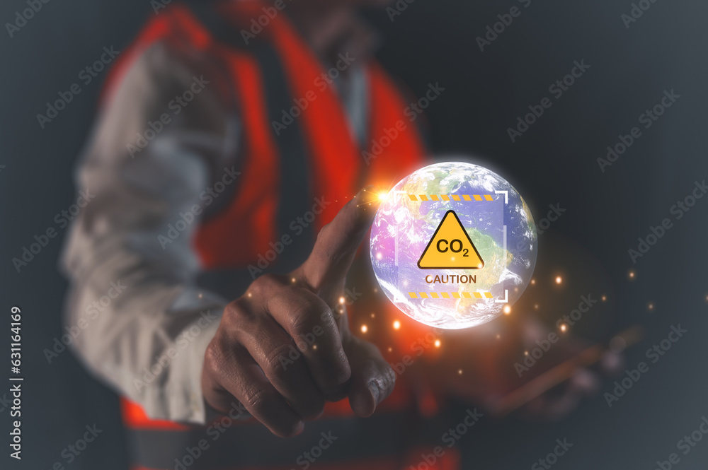 Hand holding virtual glob and caution sign CO2 reduce icon concept of ...