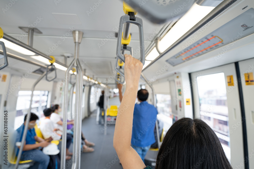 Woman hand firm grip safety handrail in elevated monorail train. Mass ...
