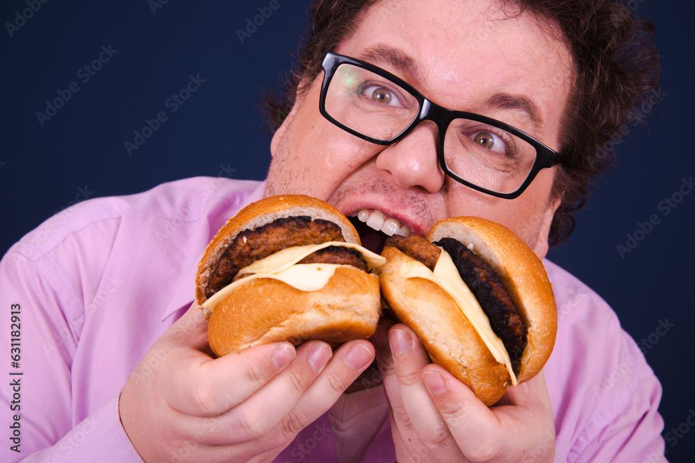 Funny hungry fat man eating burger. Stock Photo | Adobe Stock