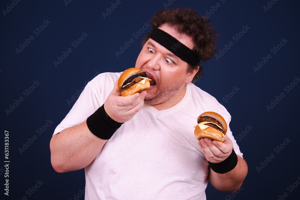 Funny hungry fat man eating burger. Stock Photo | Adobe Stock