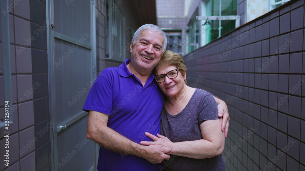 Portrait of a senior couple smiling together in loving embrace by ...