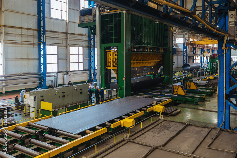 Pipe factory production line. Tube formation by roll sheet bending ...