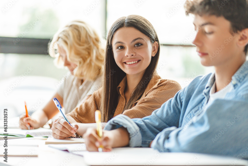 Portrait of school girl and boy studying together, learning language ...
