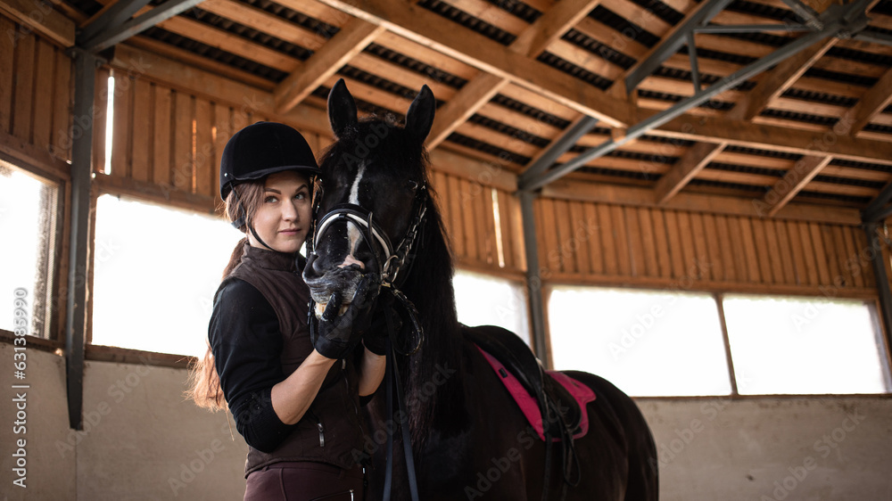 Equestrian sports. A young woman in a sports uniform, a rider and her ...